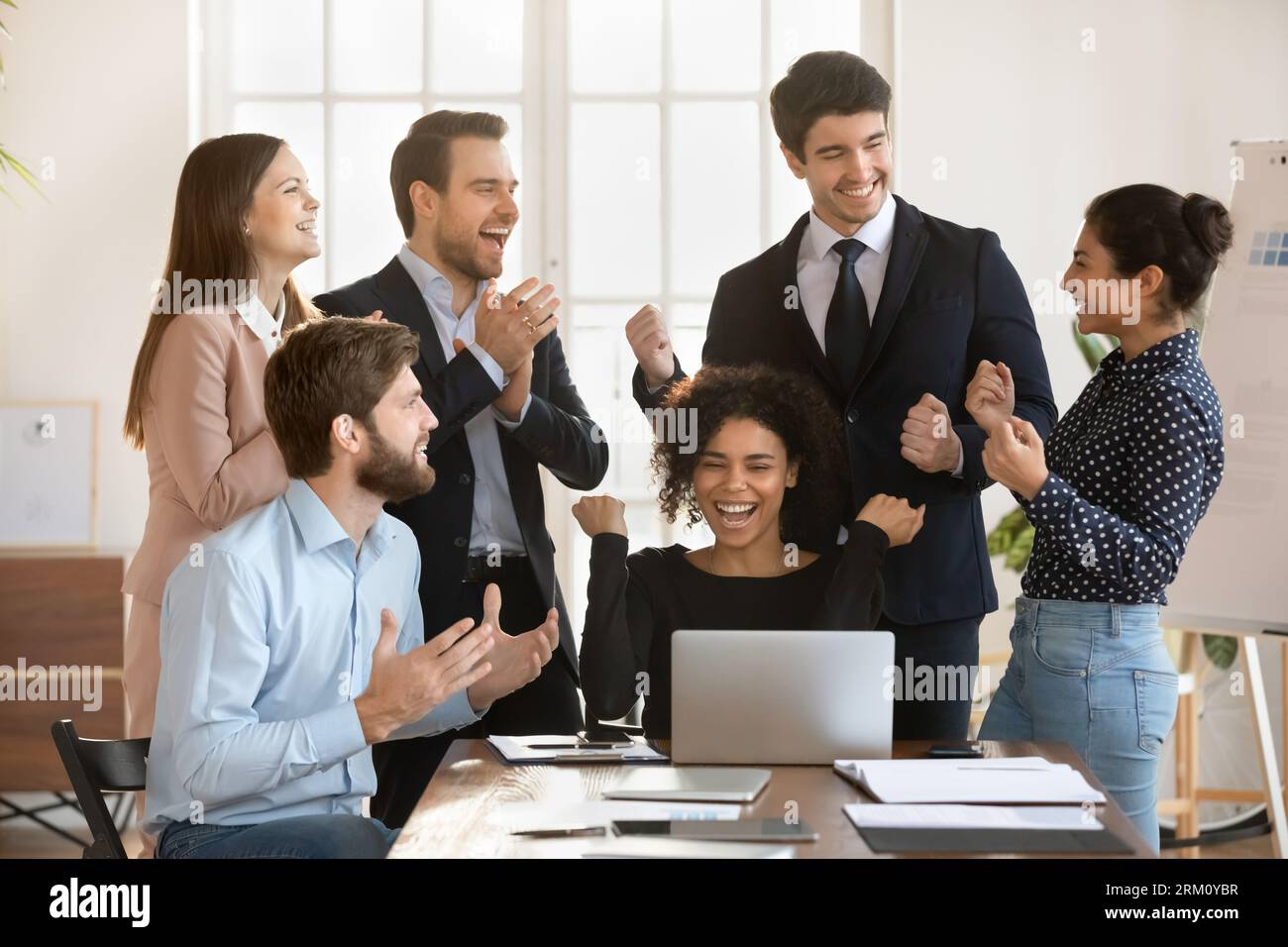 Overjoyed diverse employees celebrate team success together Stock Photo ...
