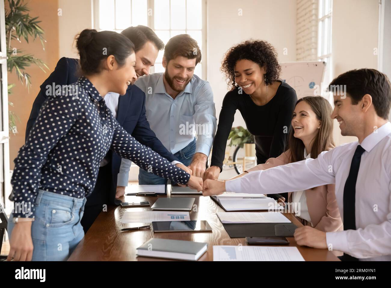 Overjoyed multiracial employees participate in teambuilding activity ...