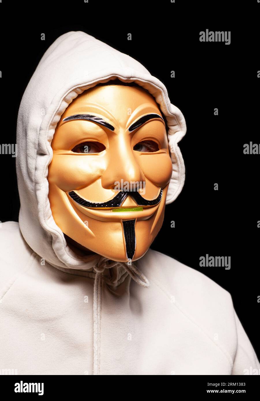 Moscow, Russia, August 23, 2023: Hacker wearing hood and gold anonymous ...