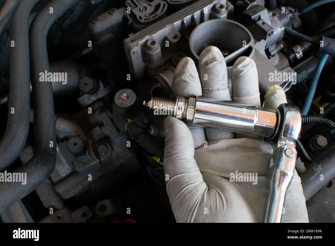 work in the workshop on parts of a car engine, spark plug of the ...