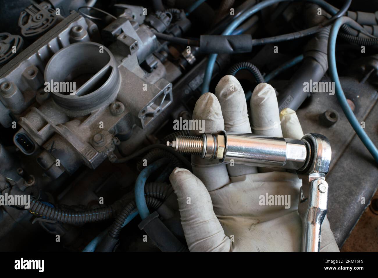 work in the workshop on parts of a car engine, spark plug of the ...