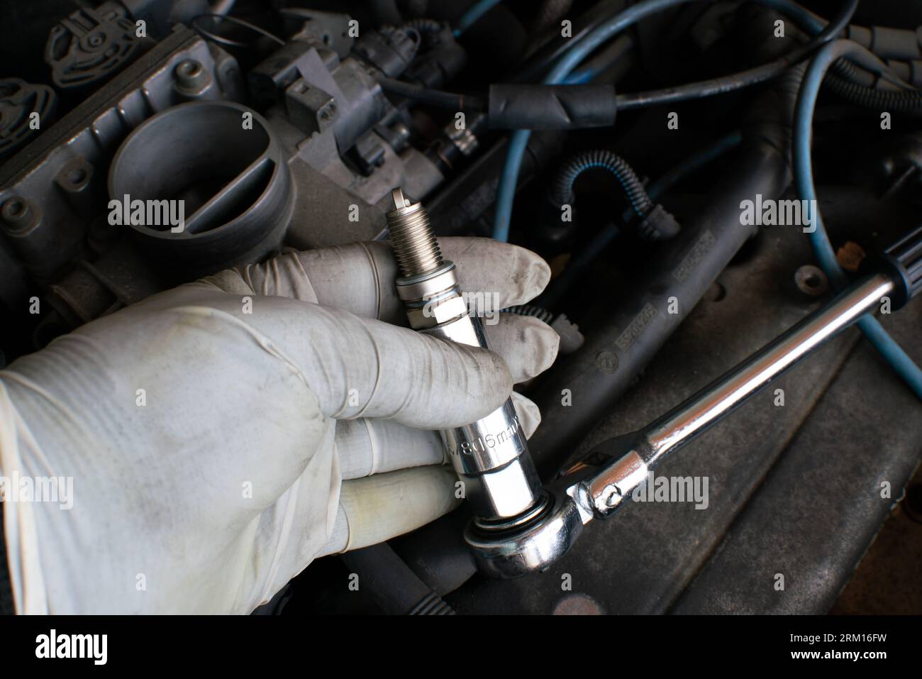 work in the workshop on parts of a car engine, spark plug of the ...