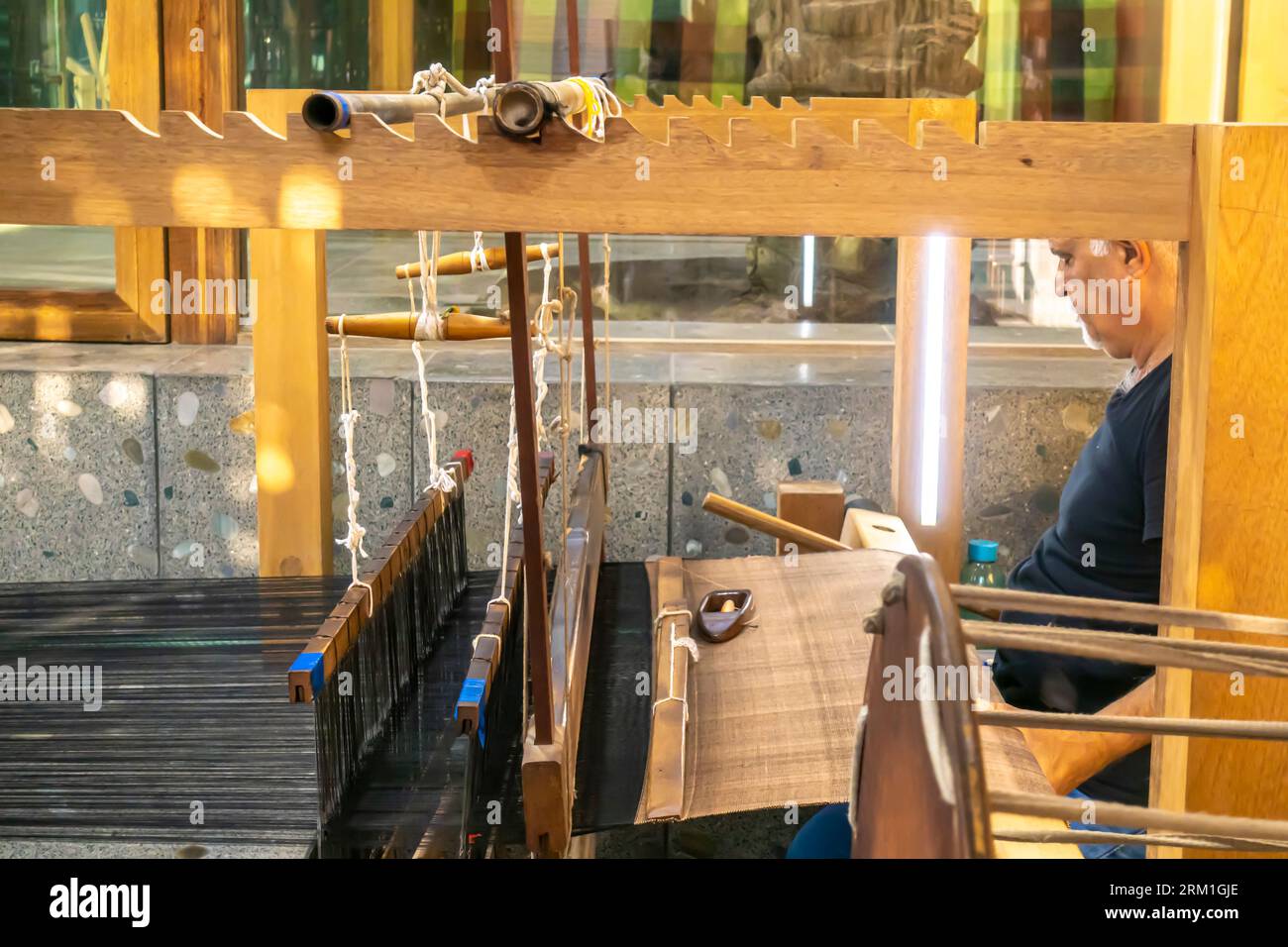 A weaving master operates the weaving textile machine at Naseej weaving ...