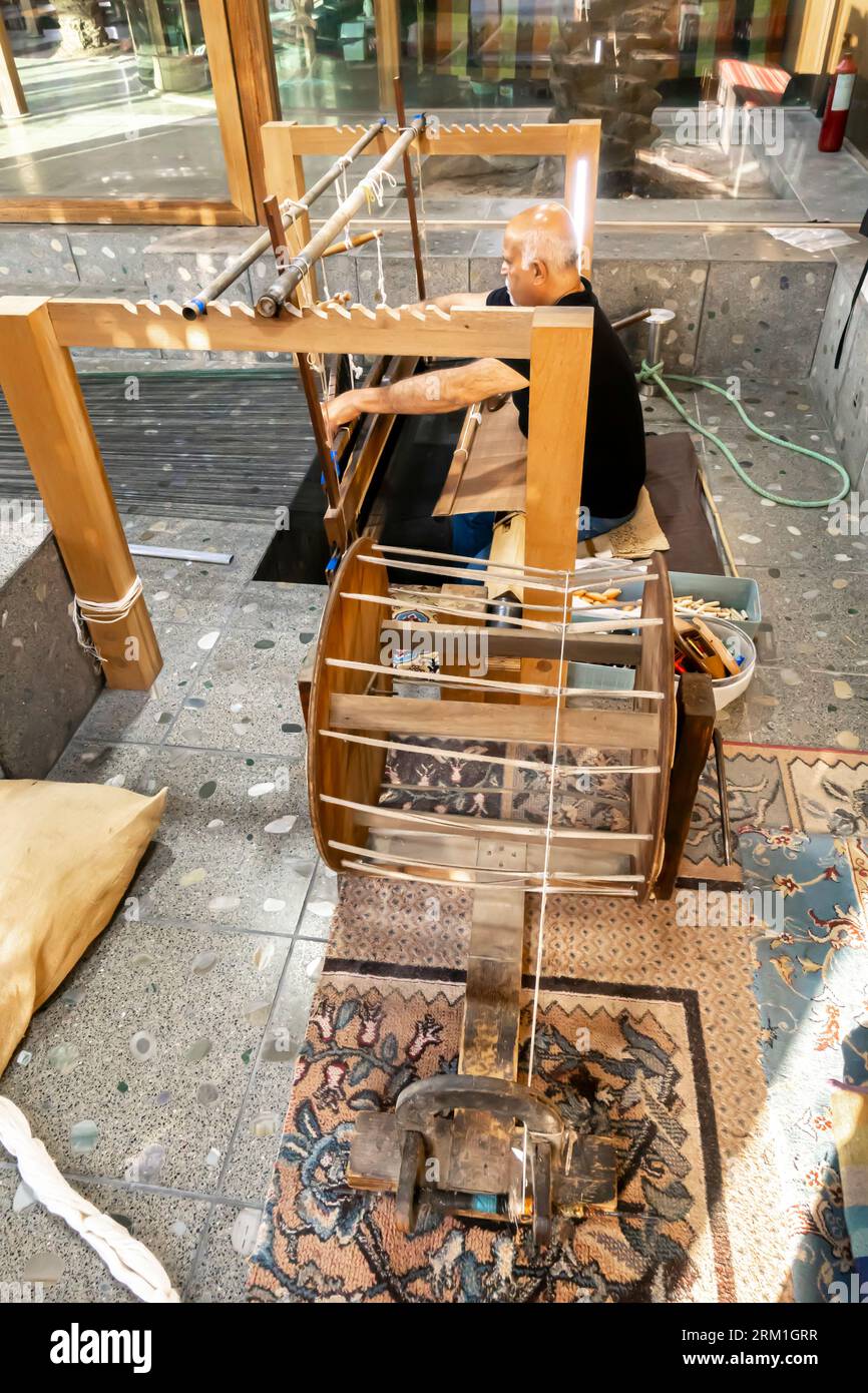 A weaving master operates the weaving textile machine at Naseej weaving ...
