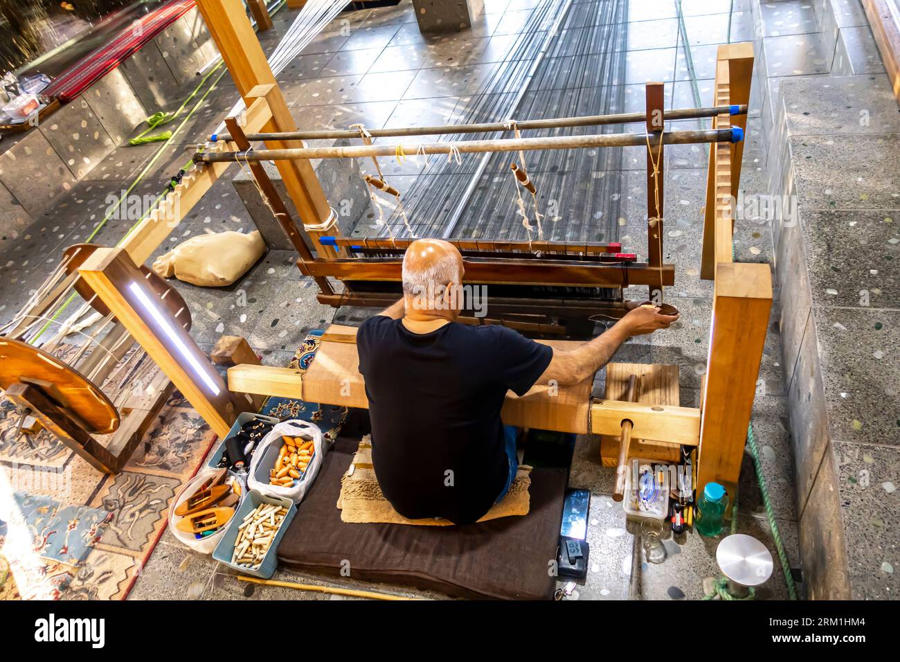A weaving master operates the weaving textile machine at Naseej weaving ...