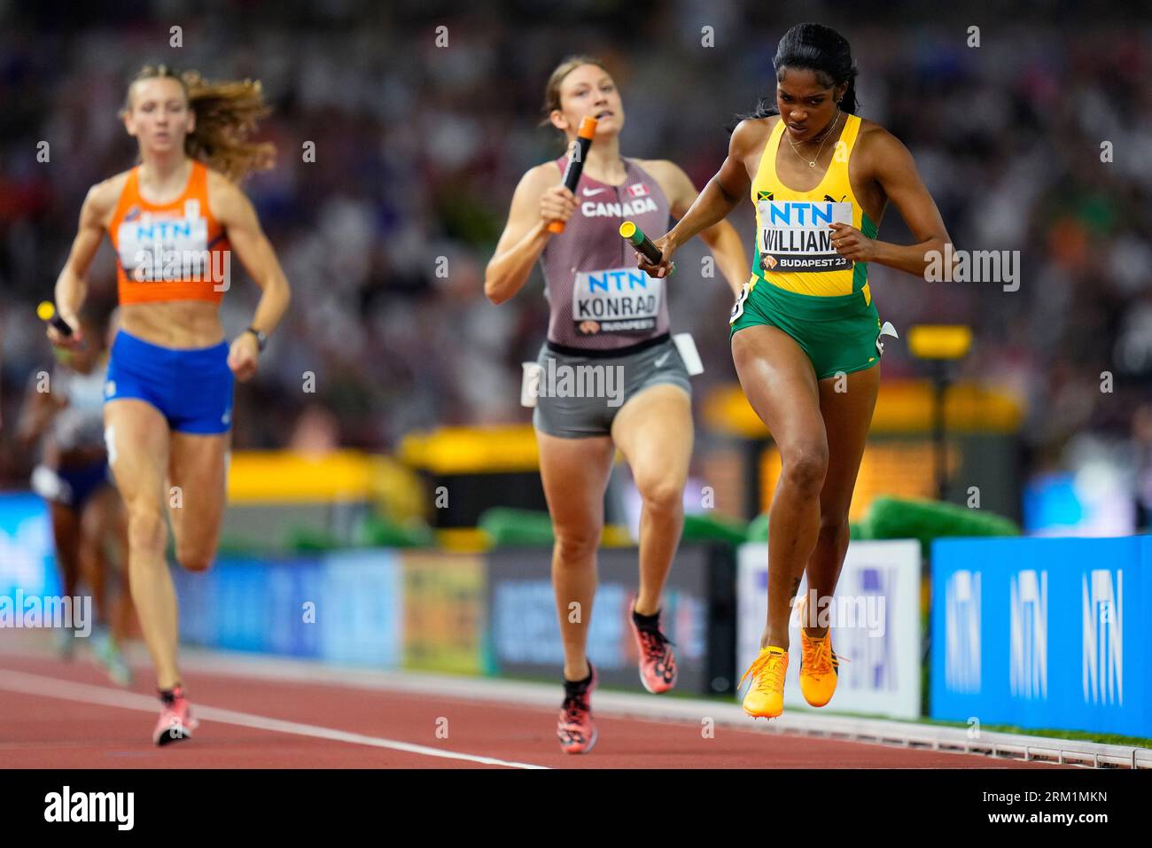 Stacey Ann Williams, of Jamaica crosses the line to anchor her team to ...