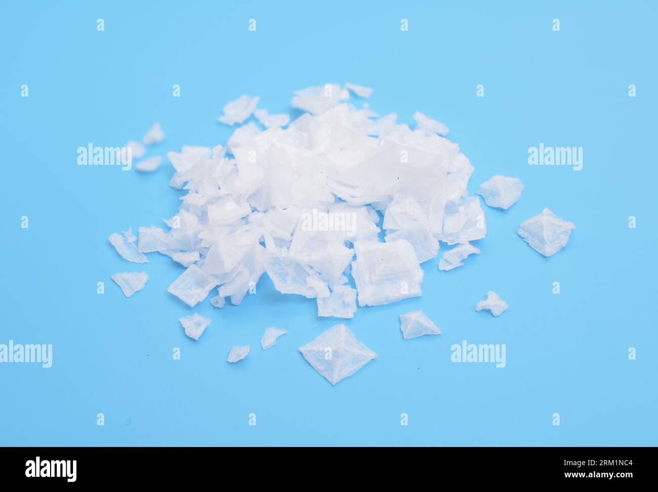 Pyramide Crystal Flakes of Cyprus Salt on blue background Stock Photo ...