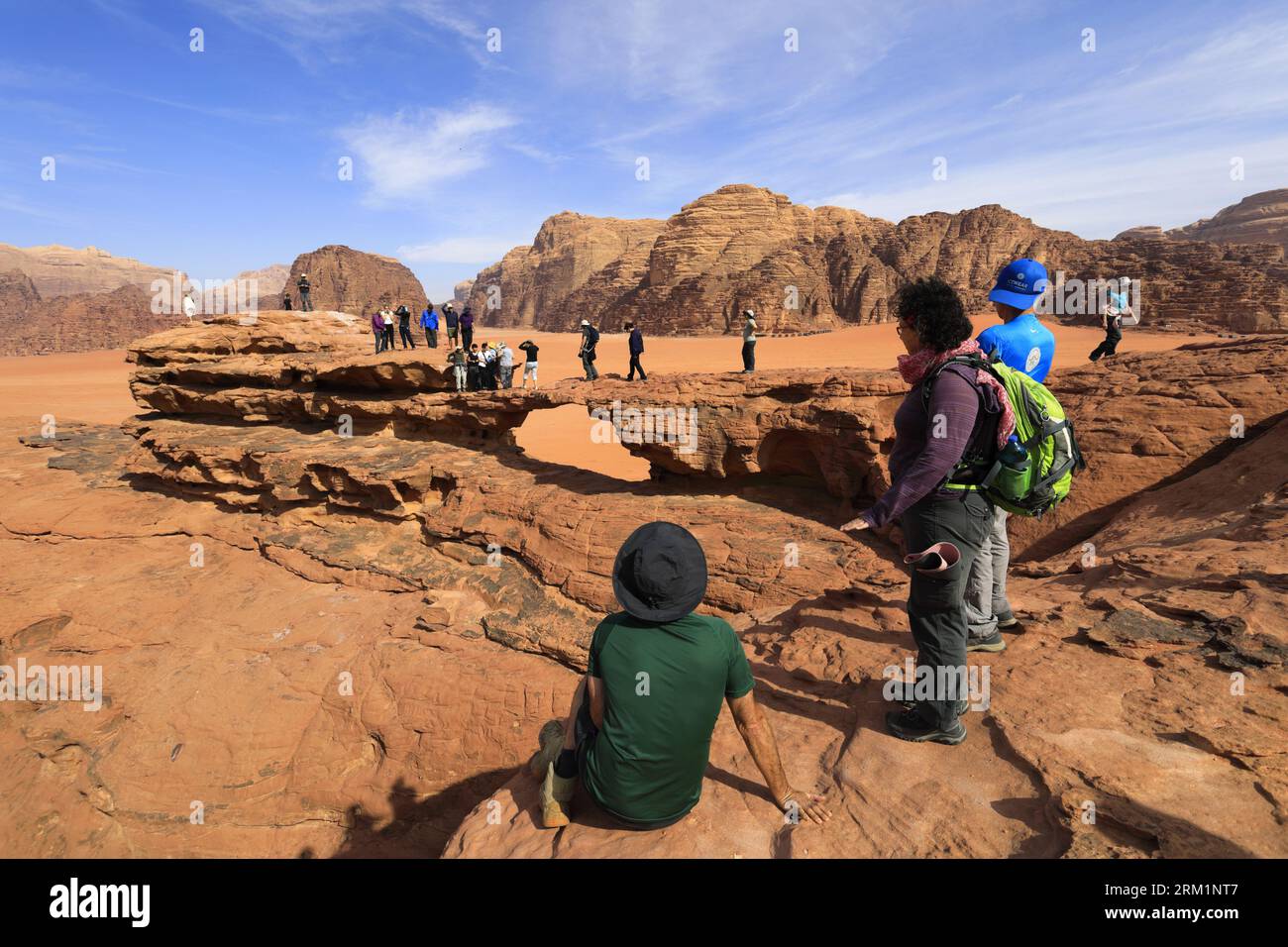 Tourists at the Little Rock bridge (Raqabat al Wadak), Wadi Rum, Unesco ...