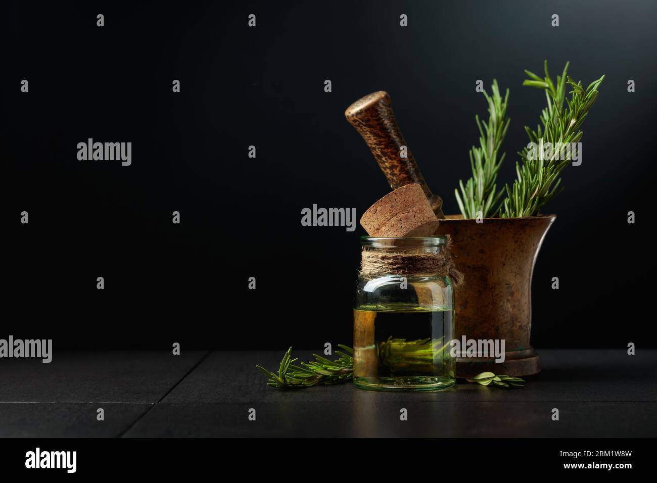 Bottle of rosemary aromatherapy oil extract with fresh rosemary ...