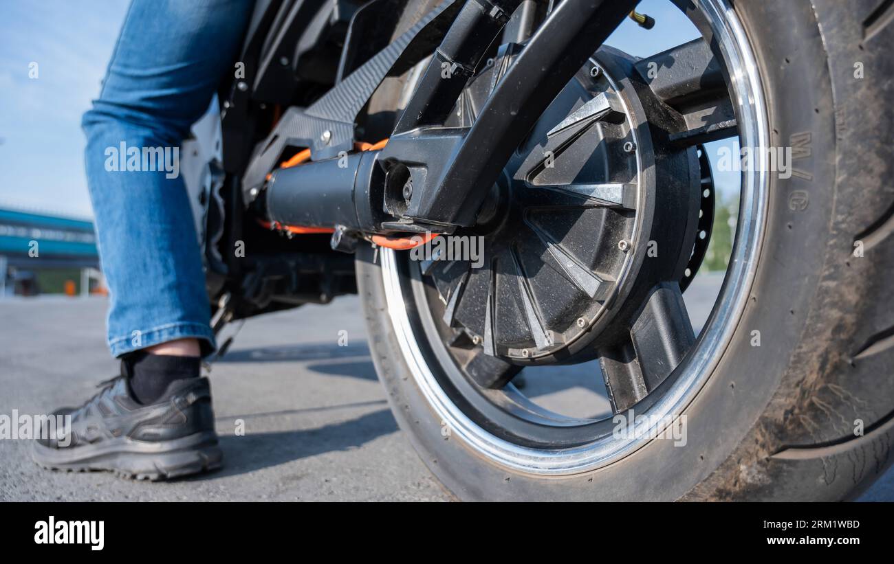 Close-up of the rear wheel with the engine of an electric motorcycle ...