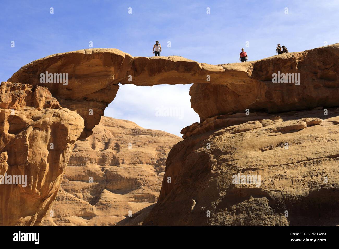 Tourists at the Burdah rock bridge, Wadi Rum, Unesco World Heritage ...