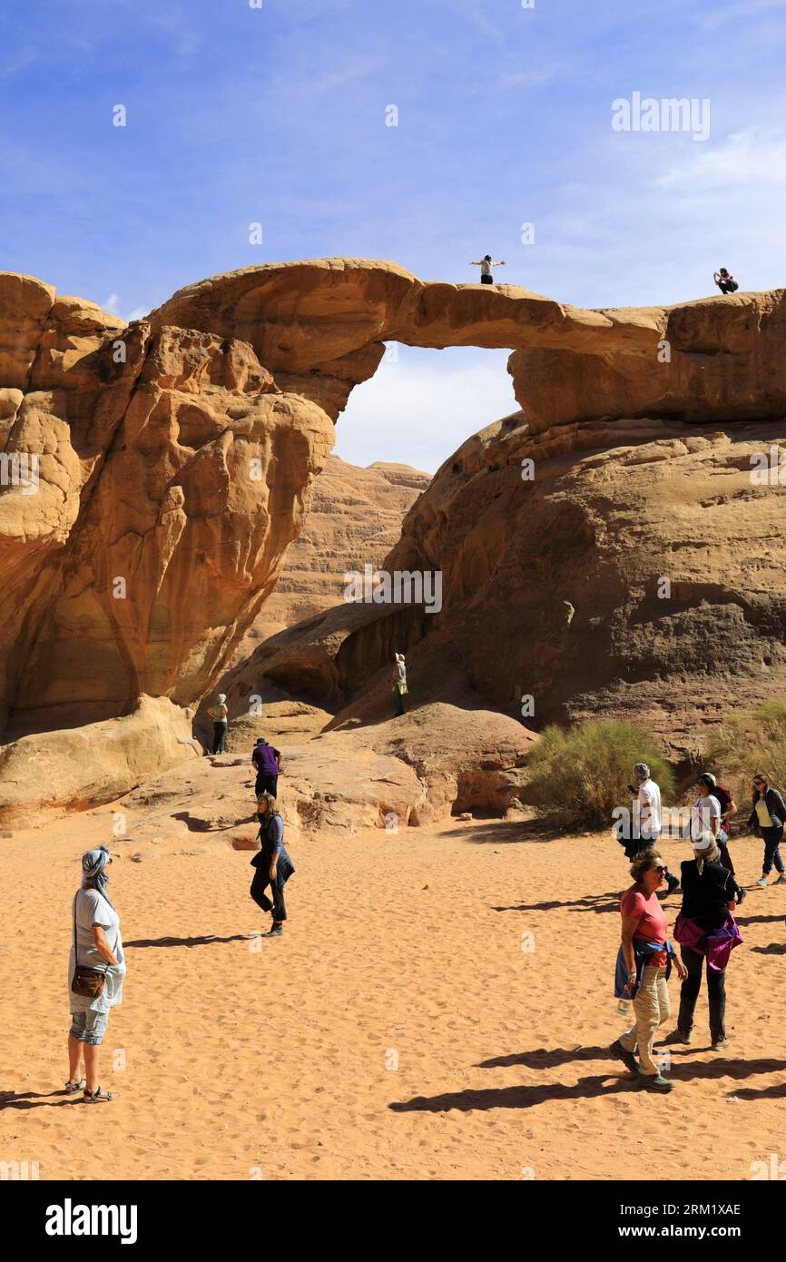 Tourists at the Burdah rock bridge, Wadi Rum, Unesco World Heritage ...