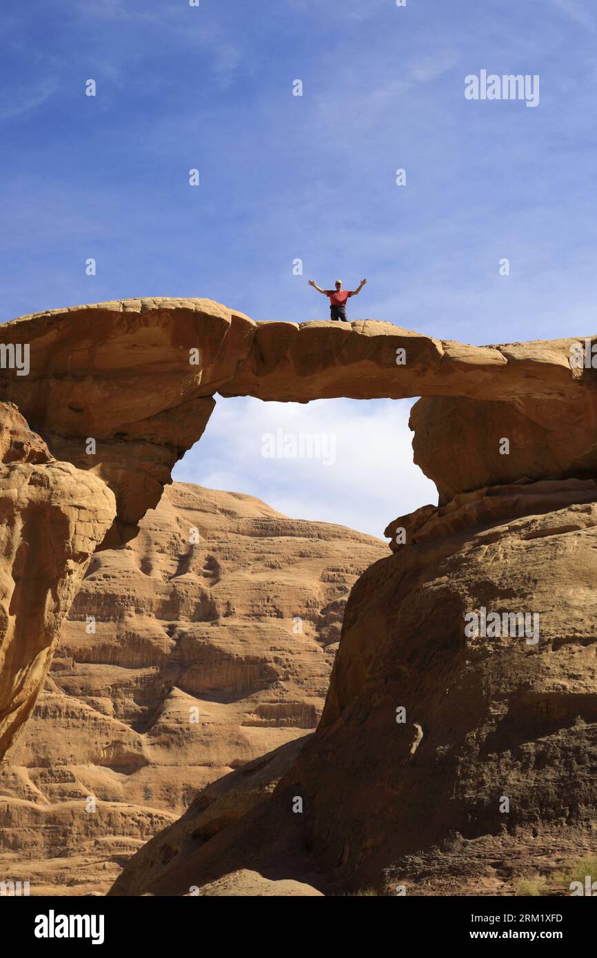 Tourists at the Burdah rock bridge, Wadi Rum, Unesco World Heritage ...
