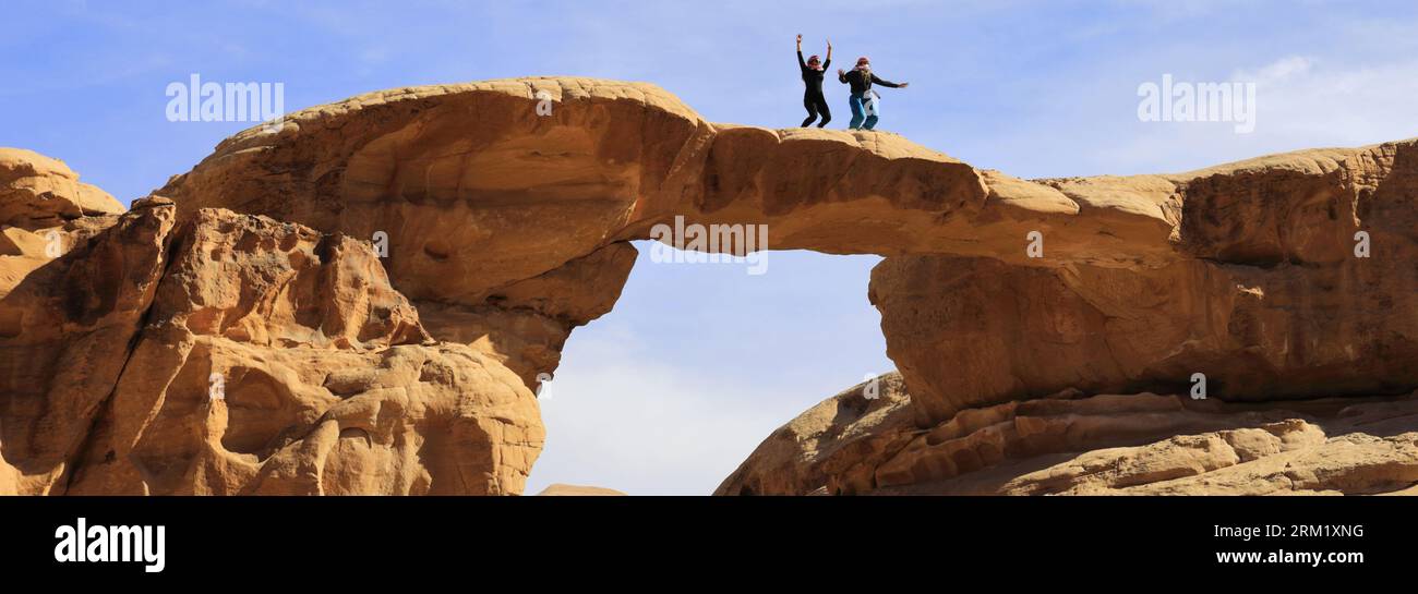 Tourists at the Burdah rock bridge, Wadi Rum, Unesco World Heritage ...