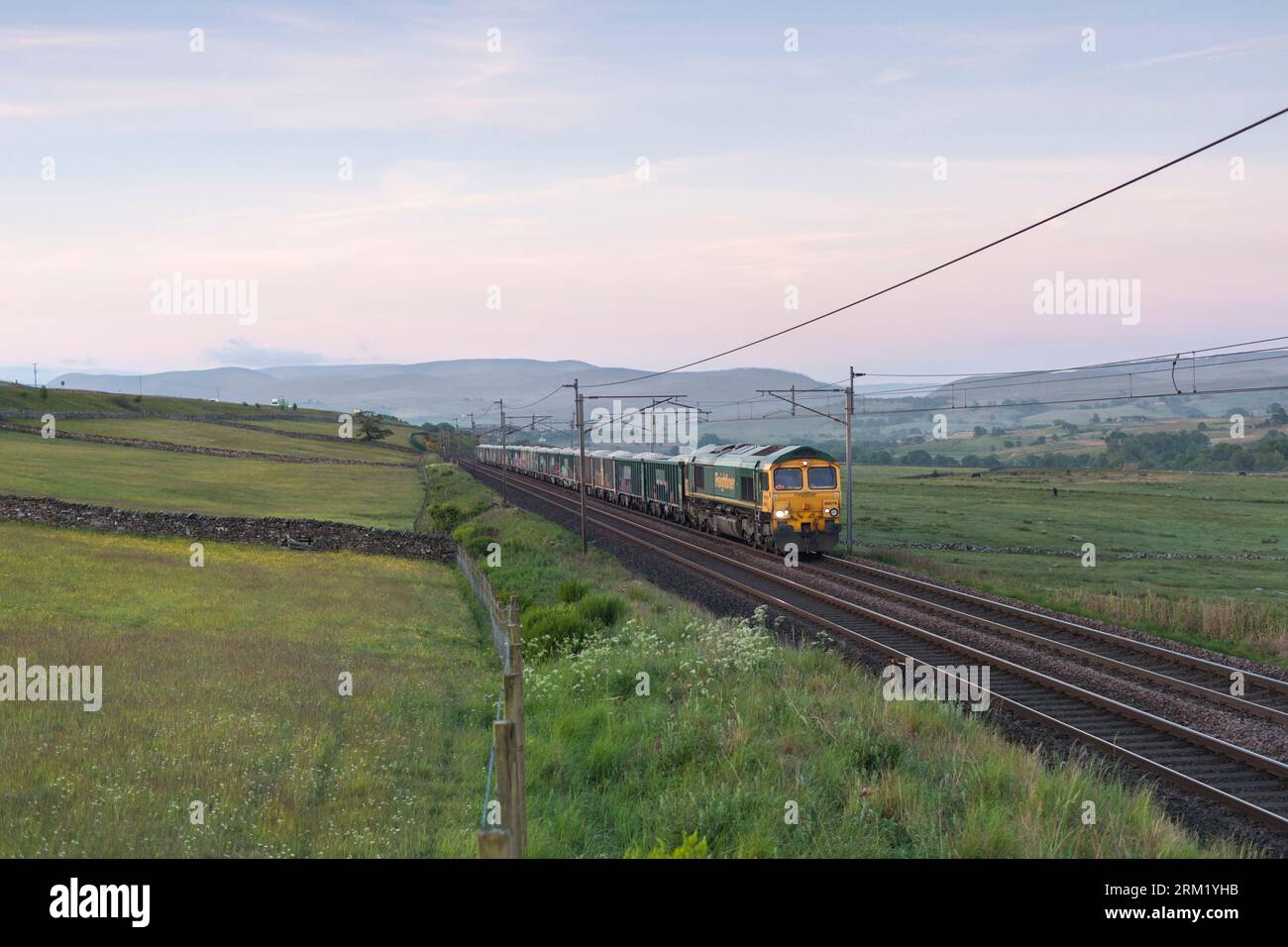 A Freightliner Class 66 locomotive climbing Shap bank, on the west ...