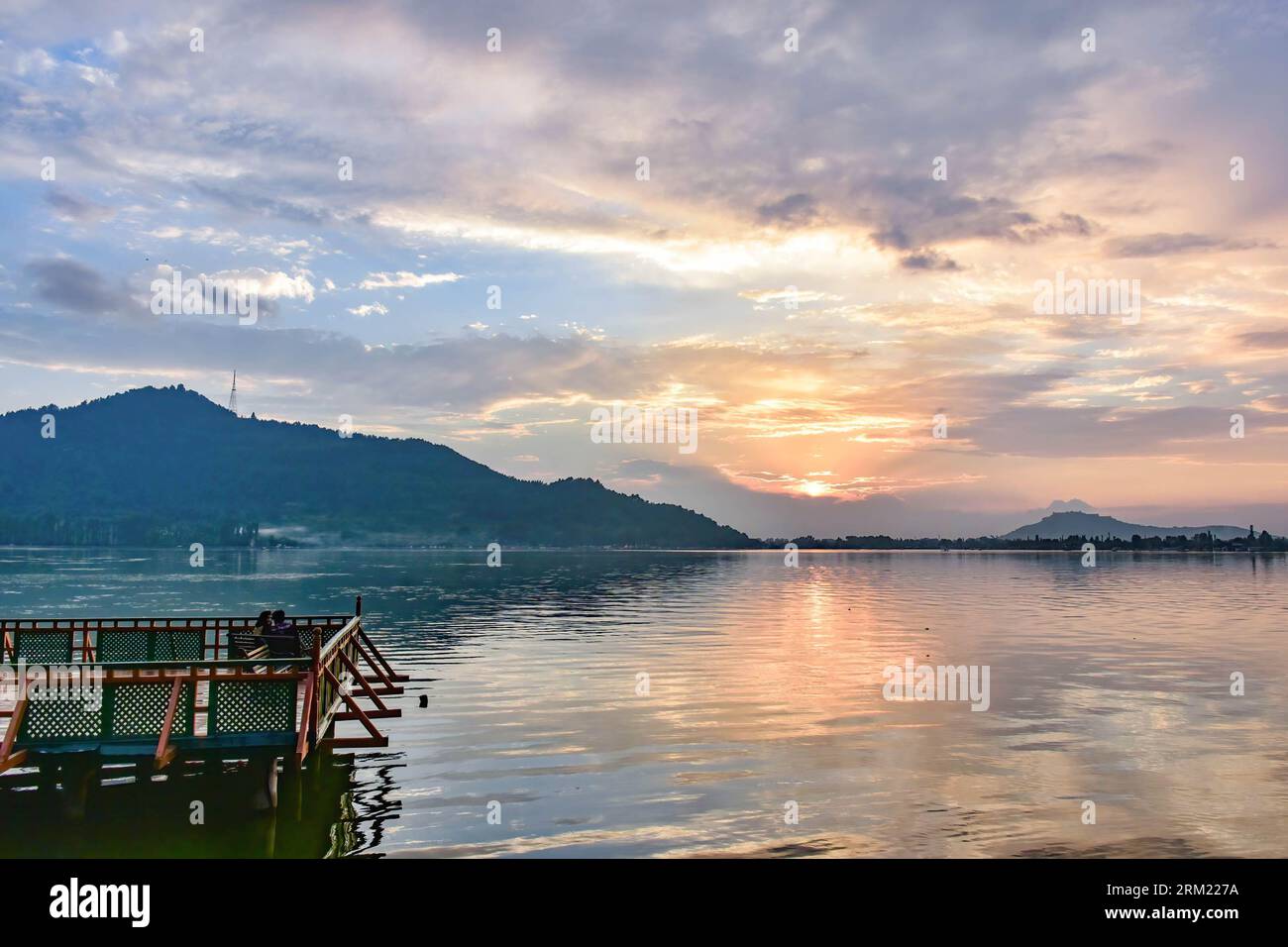 Srinagar, India. 26th Aug, 2023. A couple rests on the jetty during ...