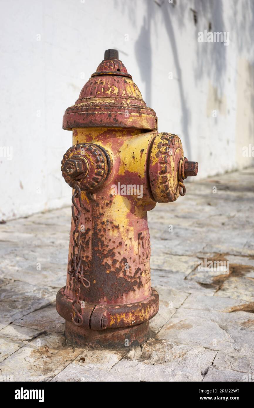 An old rusty fire hydrant on a street of Guayaquil, selective focus ...