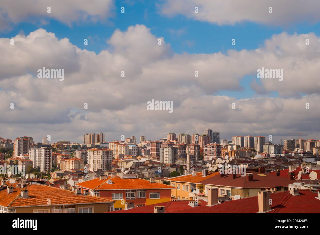 View of white clouds over turkish residential buildings in Istanbul ...