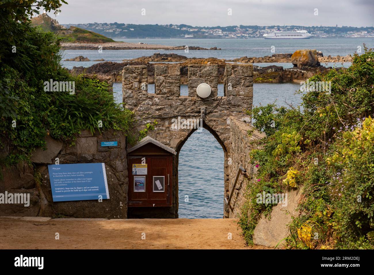 Herm, Channel Islands. 11 June 2023. Old archway entrance to the Rosaire Steps, Herm used at low ...
