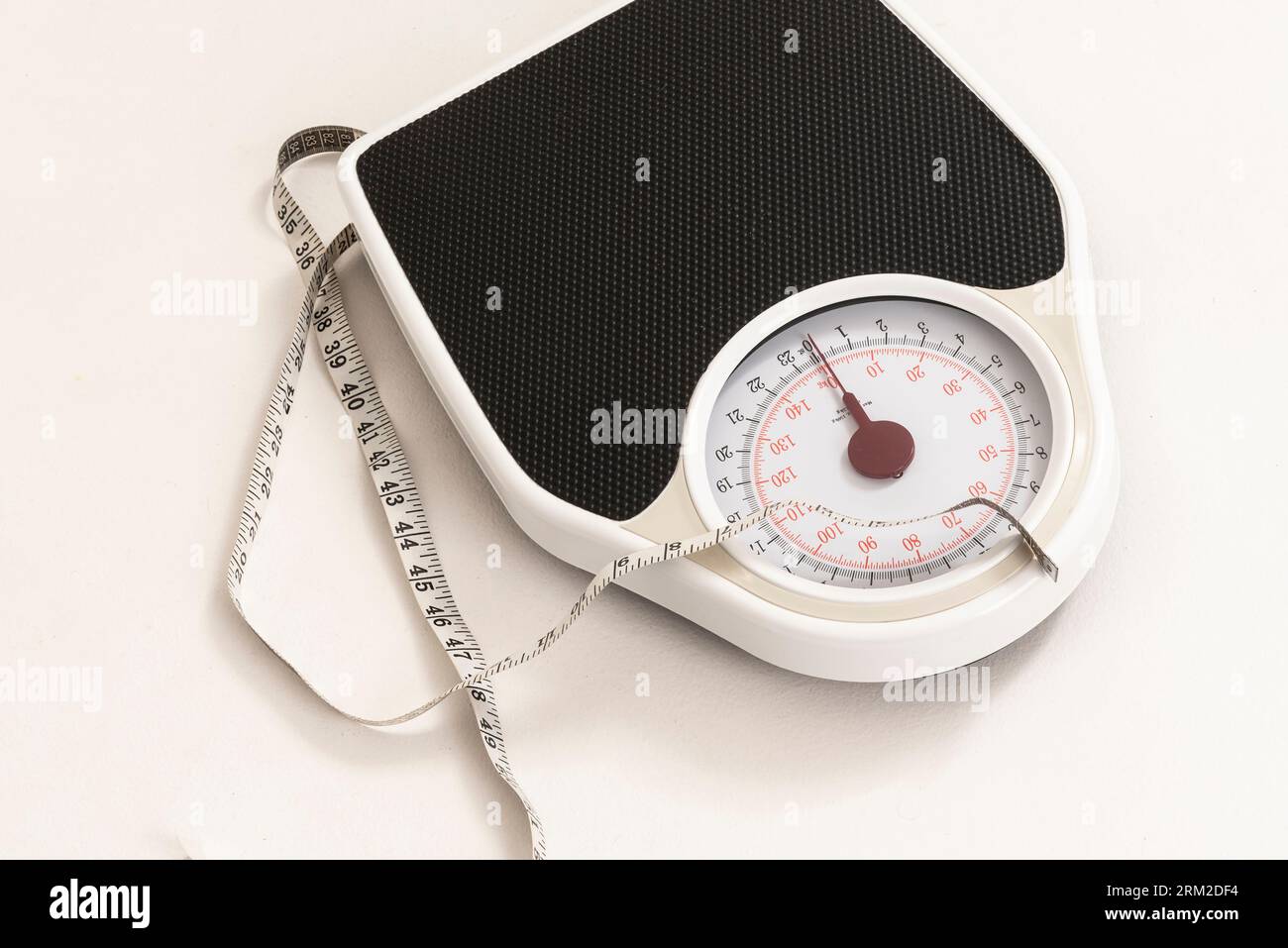 England, UK. 17 August 2023. Bathroom scales with a tape measure on a ...