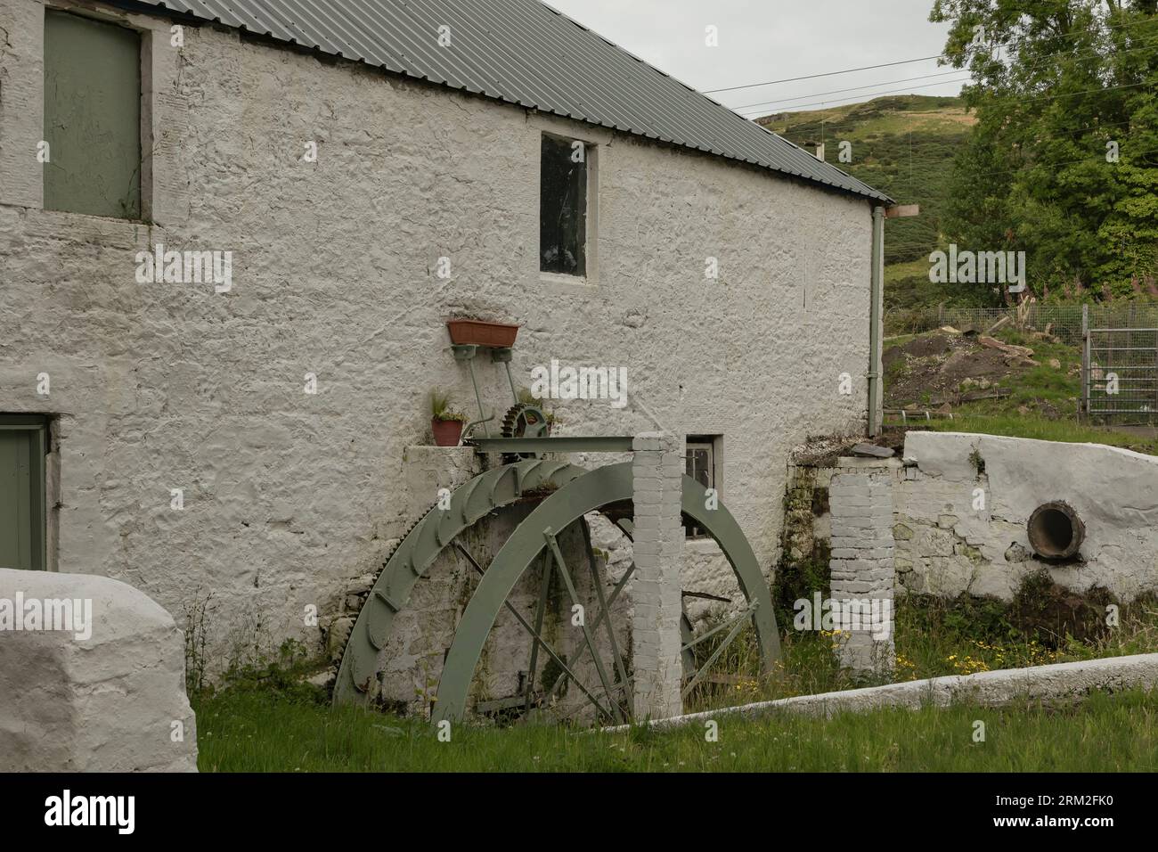 Disused water wheel at a remote scottish barn with a corrugated iron ...