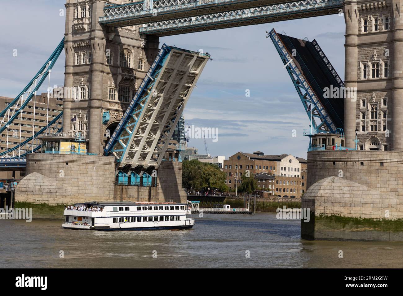 London's iconic Tower Bridge in its raised position Stock Photo - Alamy