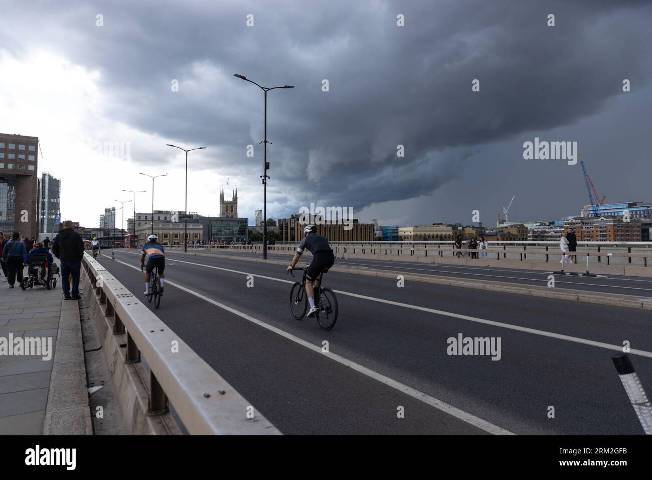 London, UK. August 26, 2023. Bikers crossing London Bridge on a cloudy ...