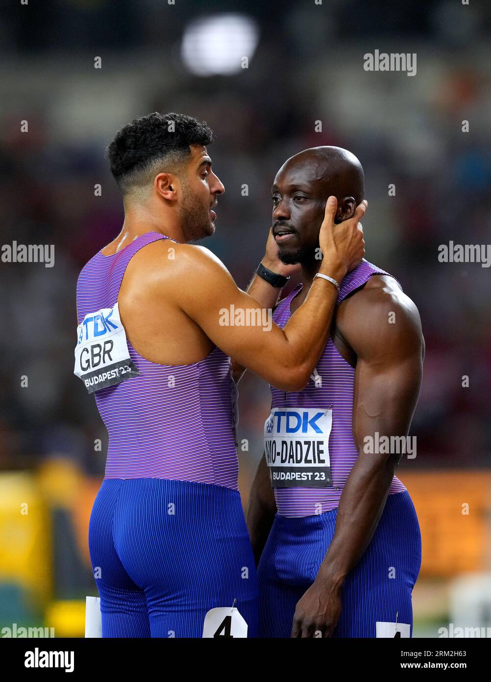 Great Britain's Eugene Amo-Dadzie is comforted by team-mate Adam Gemili ...