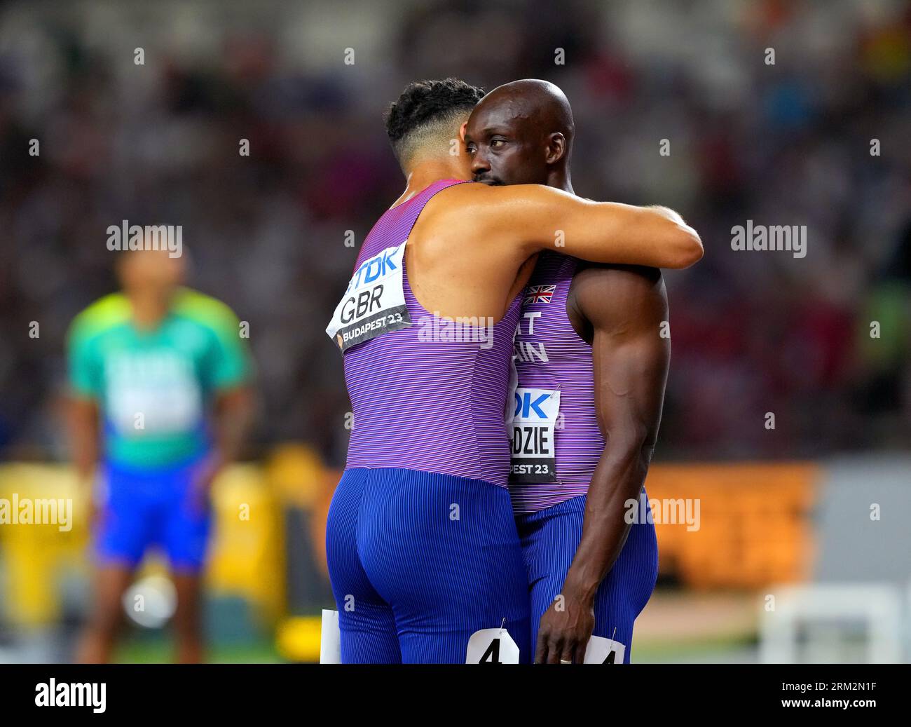 Great Britain's Eugene Amo-Dadzie is comforted by team-mate Adam Gemili ...