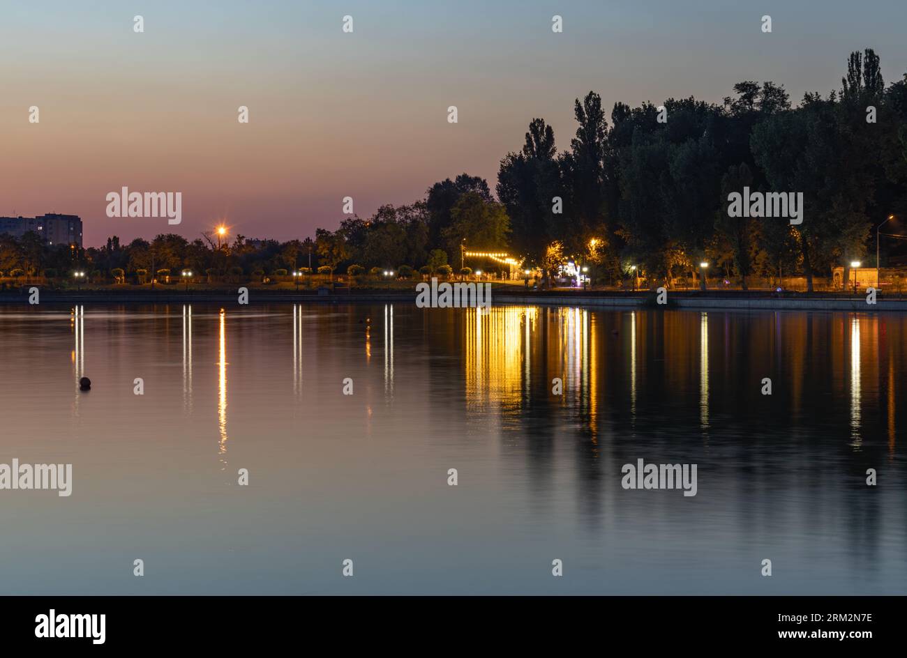 Beautiful sunset and lights reflection on a lake in a public park in ...
