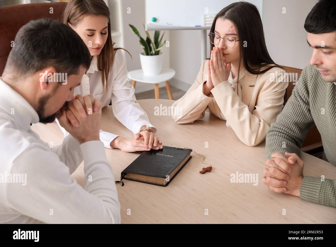 Group business people praying together hi-res stock photography and ...