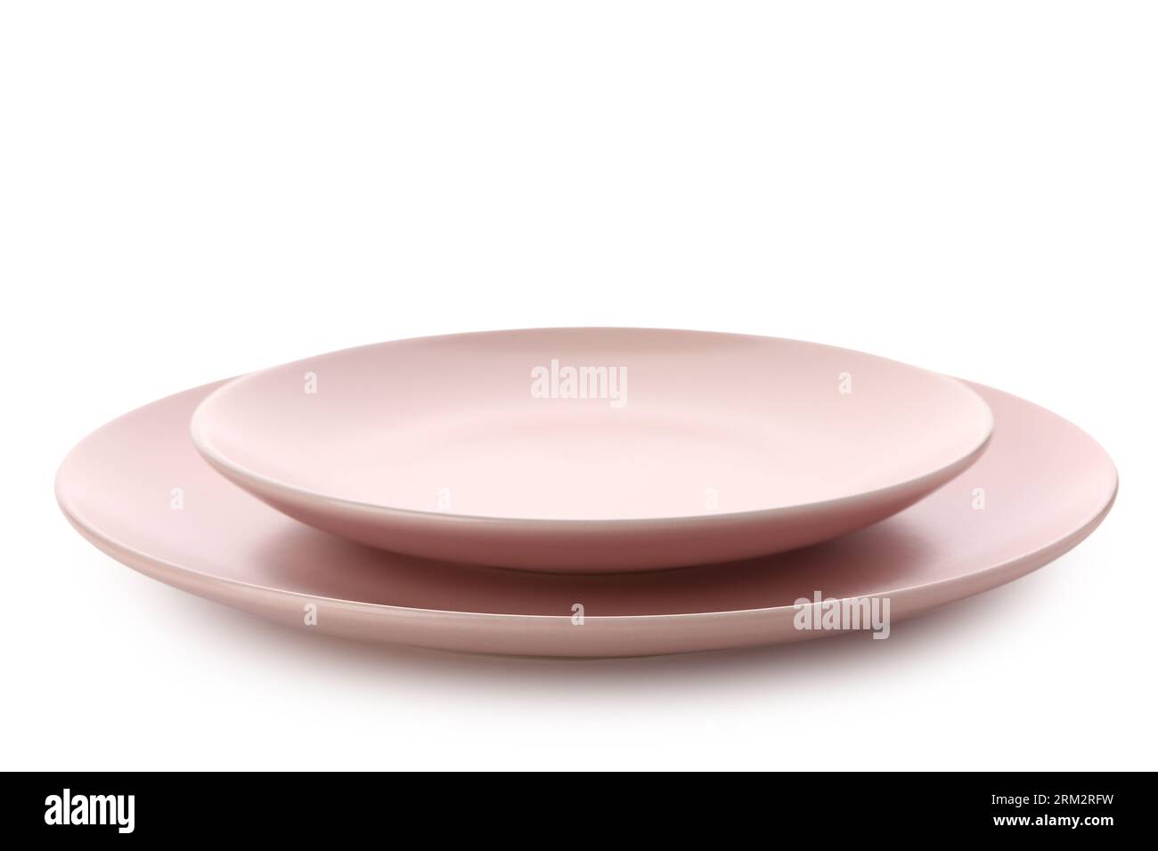 Pink ceramic plates on white background Stock Photo - Alamy