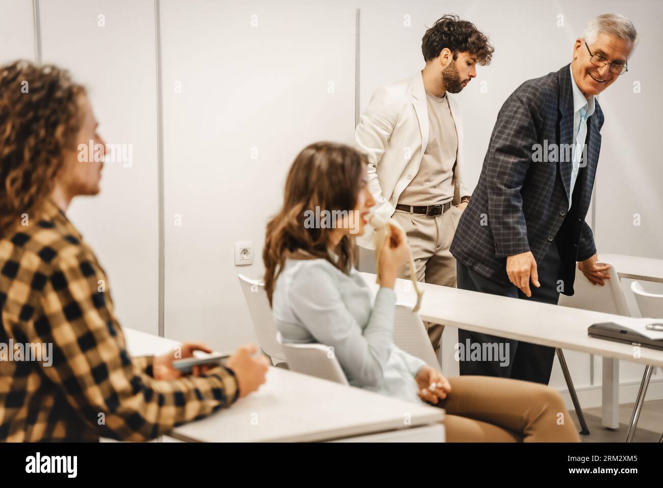 Business education concept in the classroom. Business people about to ...