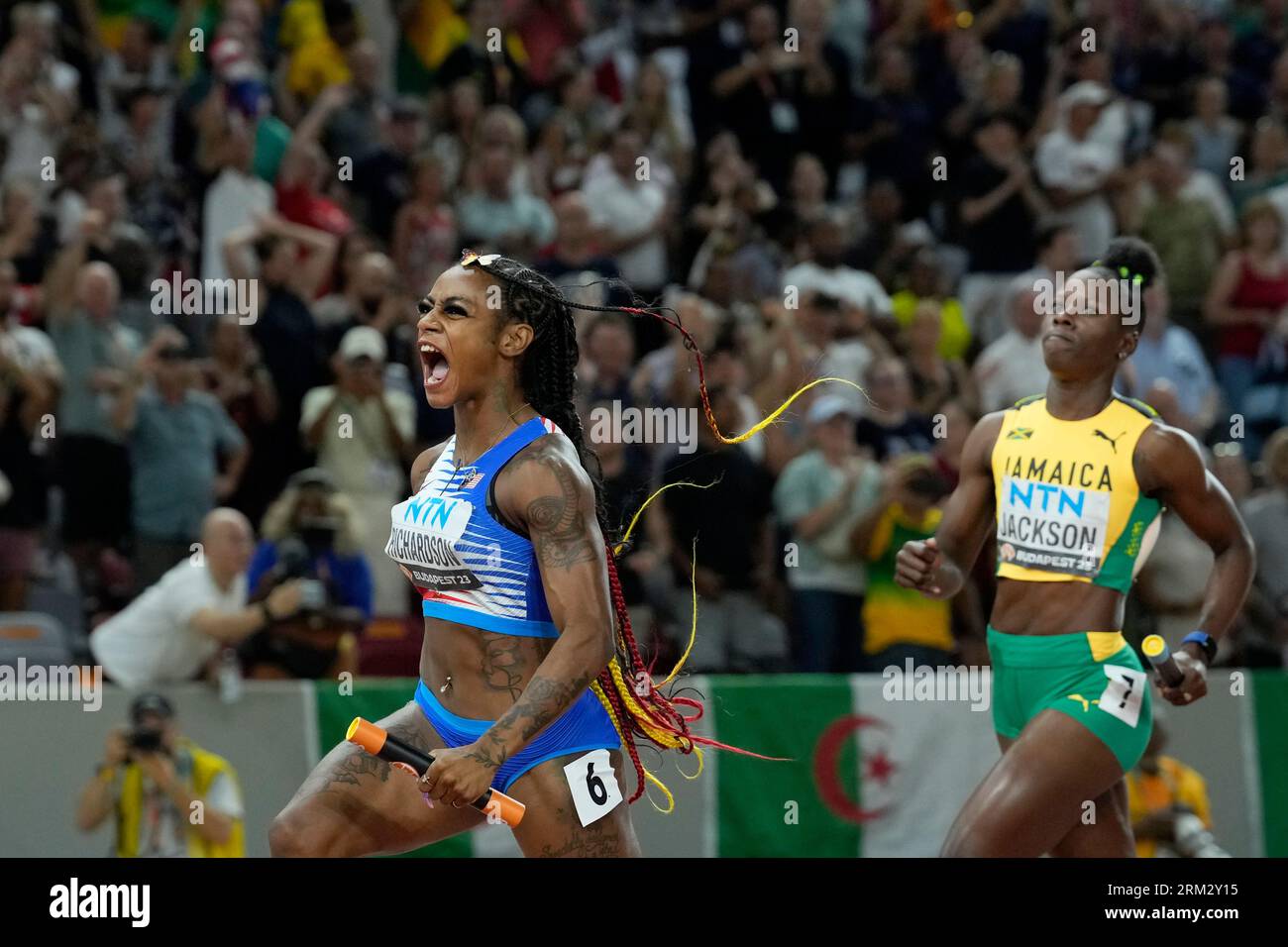 Sha'Carri Richardson, from the United States, crosses the finish line ...