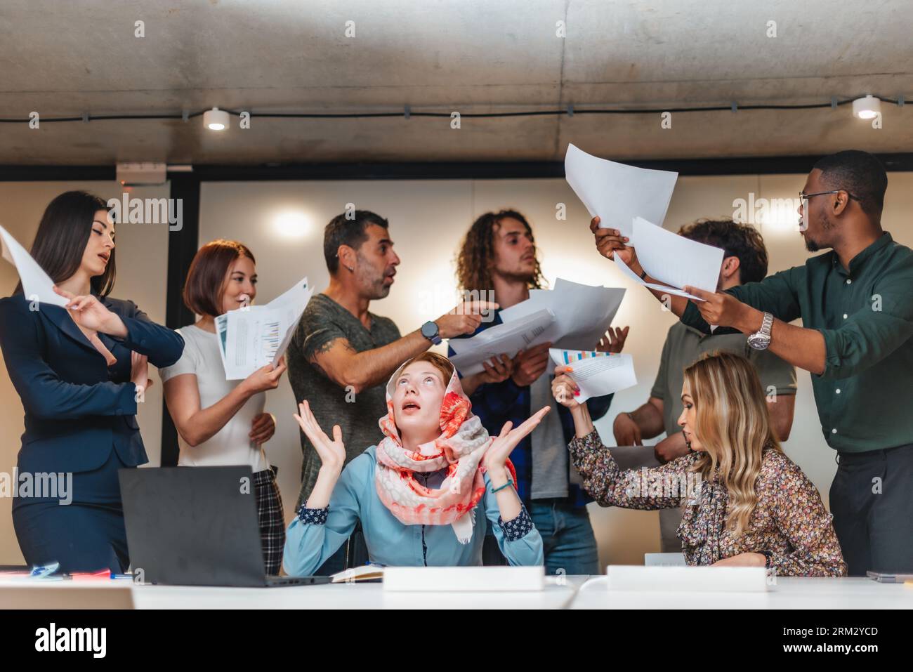 Inter-generational start-up team arguing at blaming each other at ...