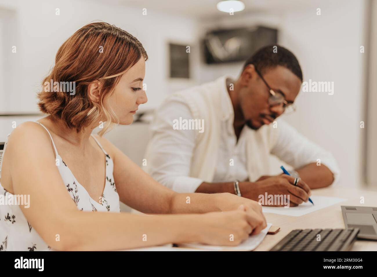 A diverse team of colleagues collaborating in an office, analyzing ...