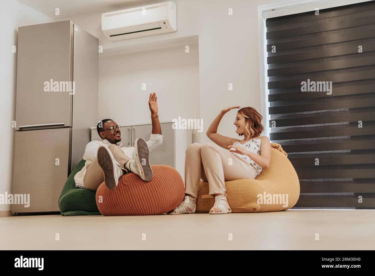 Happy, tired, diverse colleagues taking a break from work at the office ...