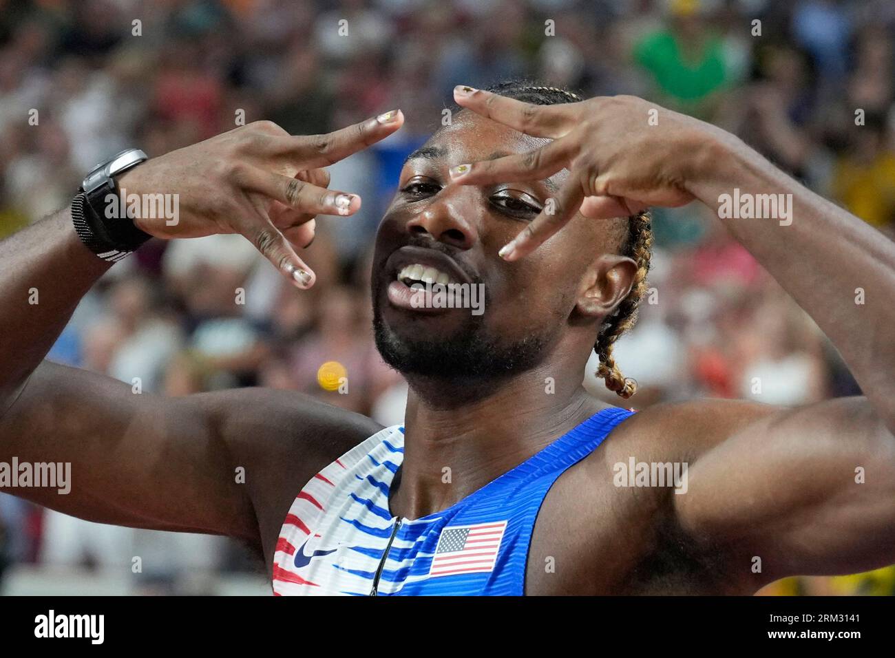 Noah Lyles, from the United States, gestures after crossing the finish ...