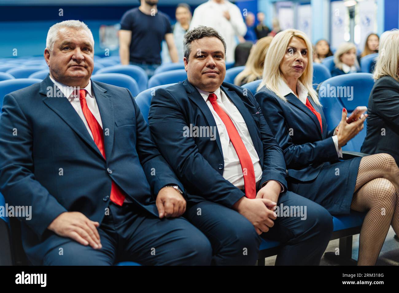 Three mature adult professors sitting together in the front row of the ...