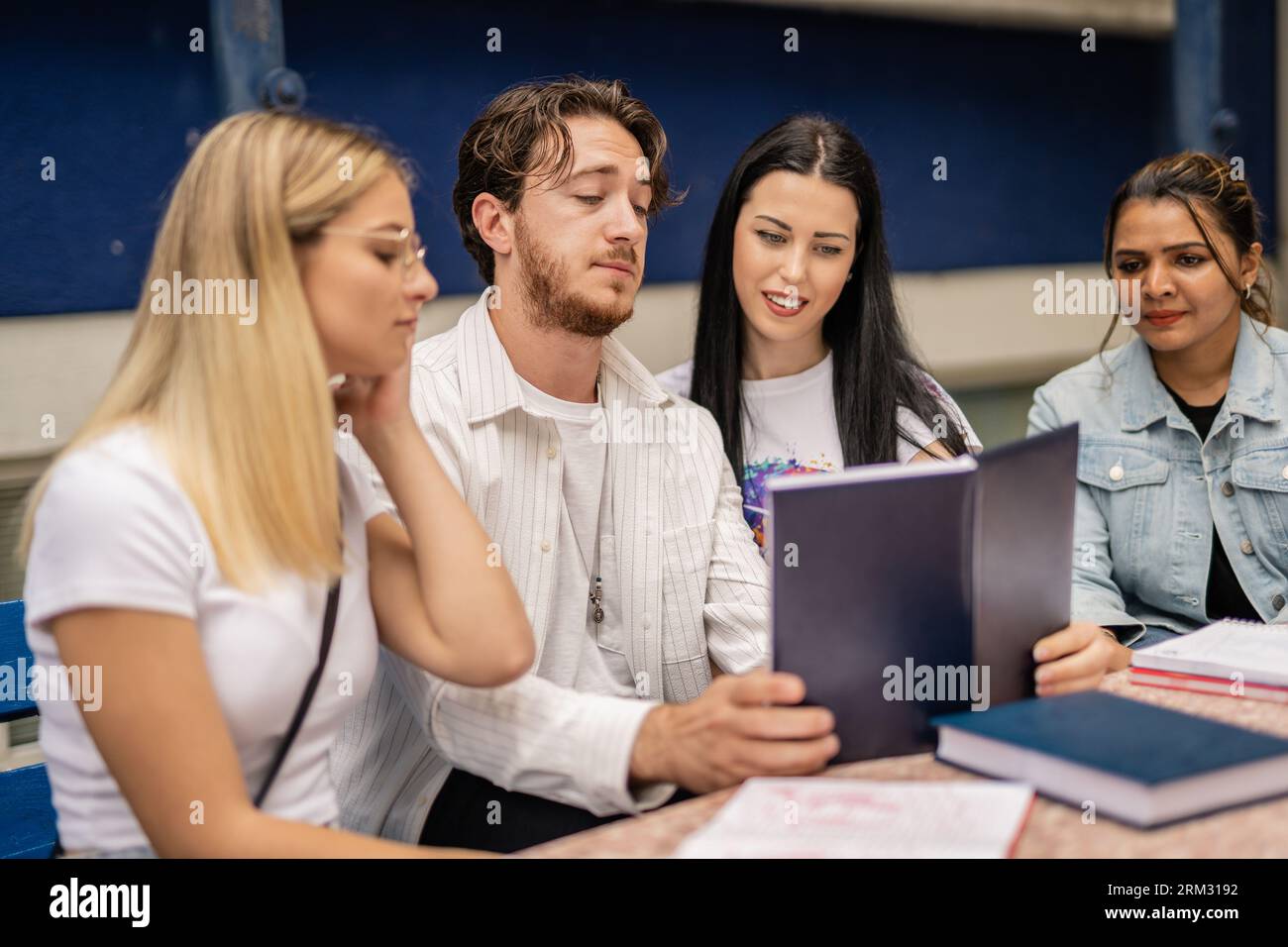 Male university assistant working on a school assignment with his ...