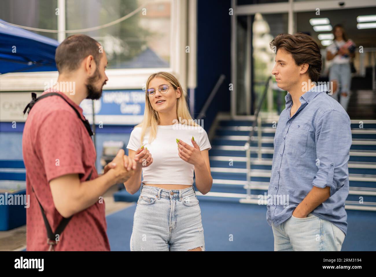 Young students having a conversation with their professor during break ...