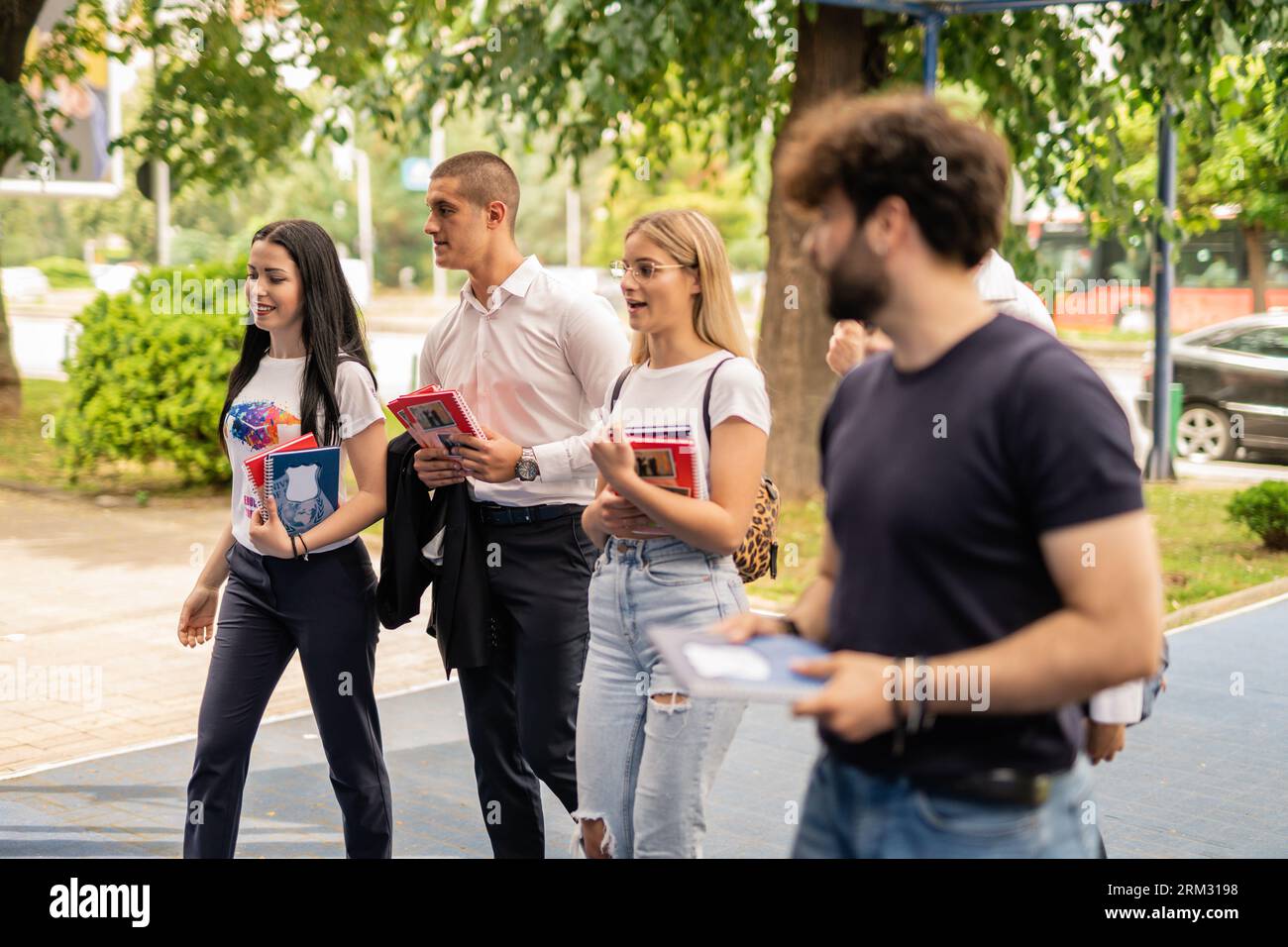 Happy, smiley, positive students going home after school discussing ...