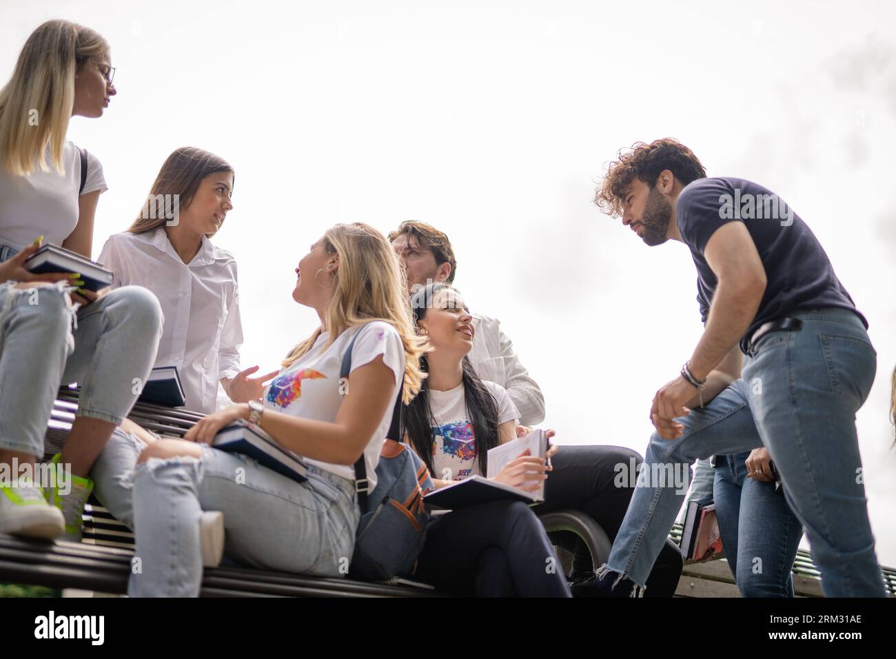 Happy, successful, college students comparing answers after exam while ...