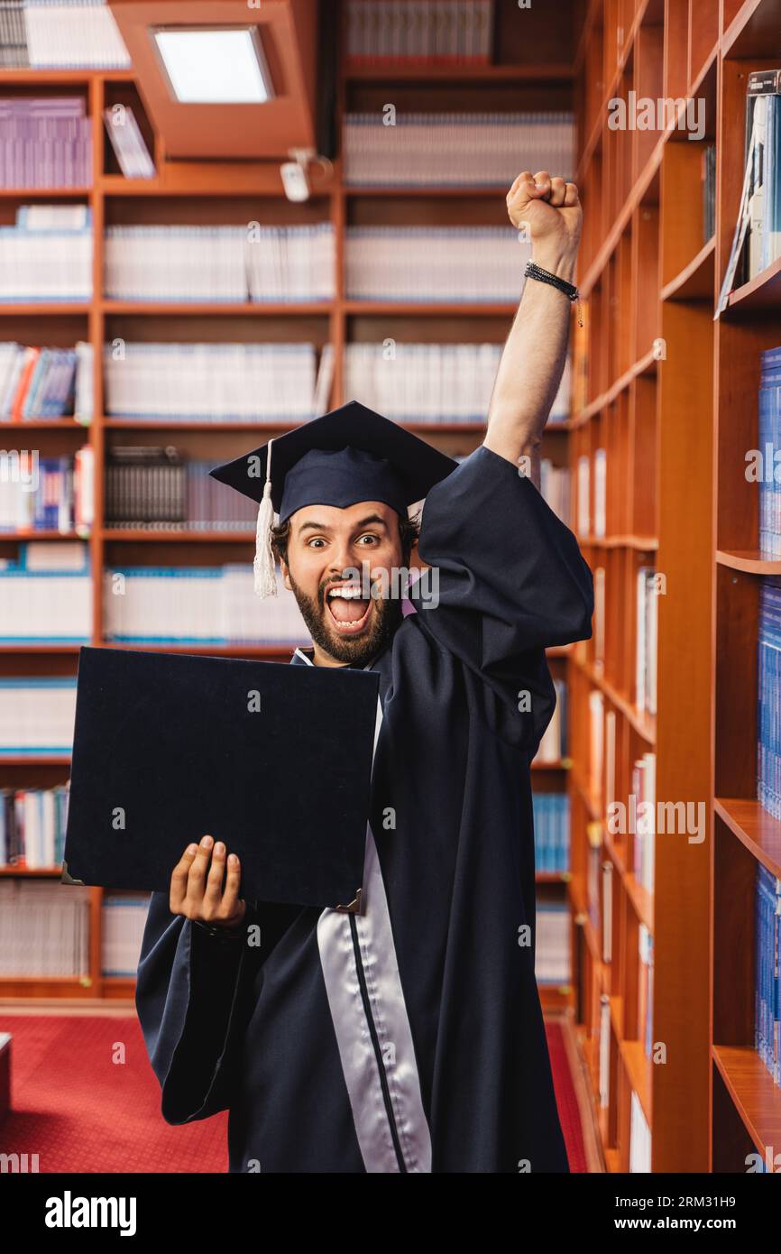 Thrilled university graduate celebrating on getting his bachelor's ...