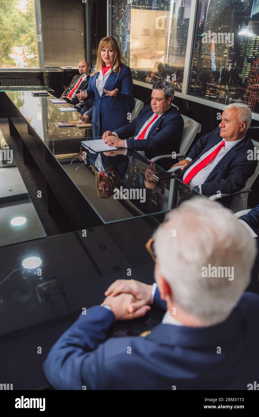 University headmaster listening to his mature female professor giving ...