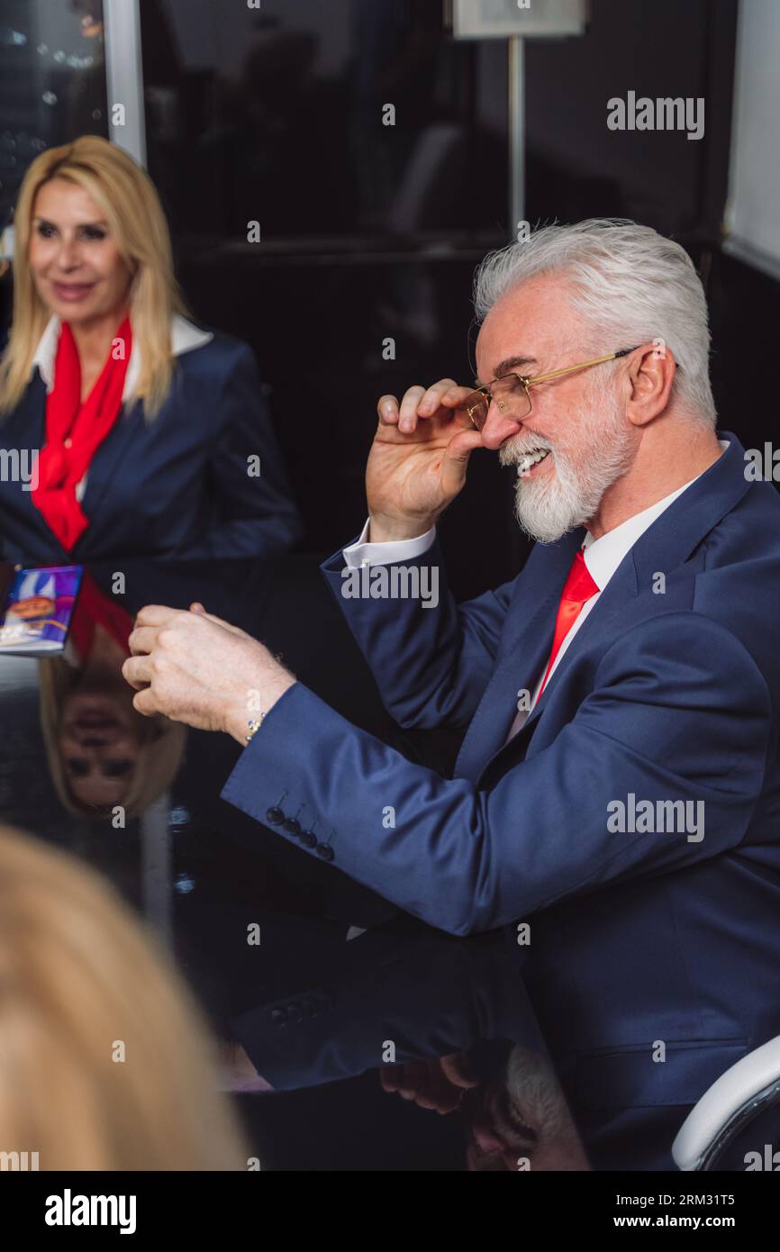 University rector discussing with his professors during meeting, having ...