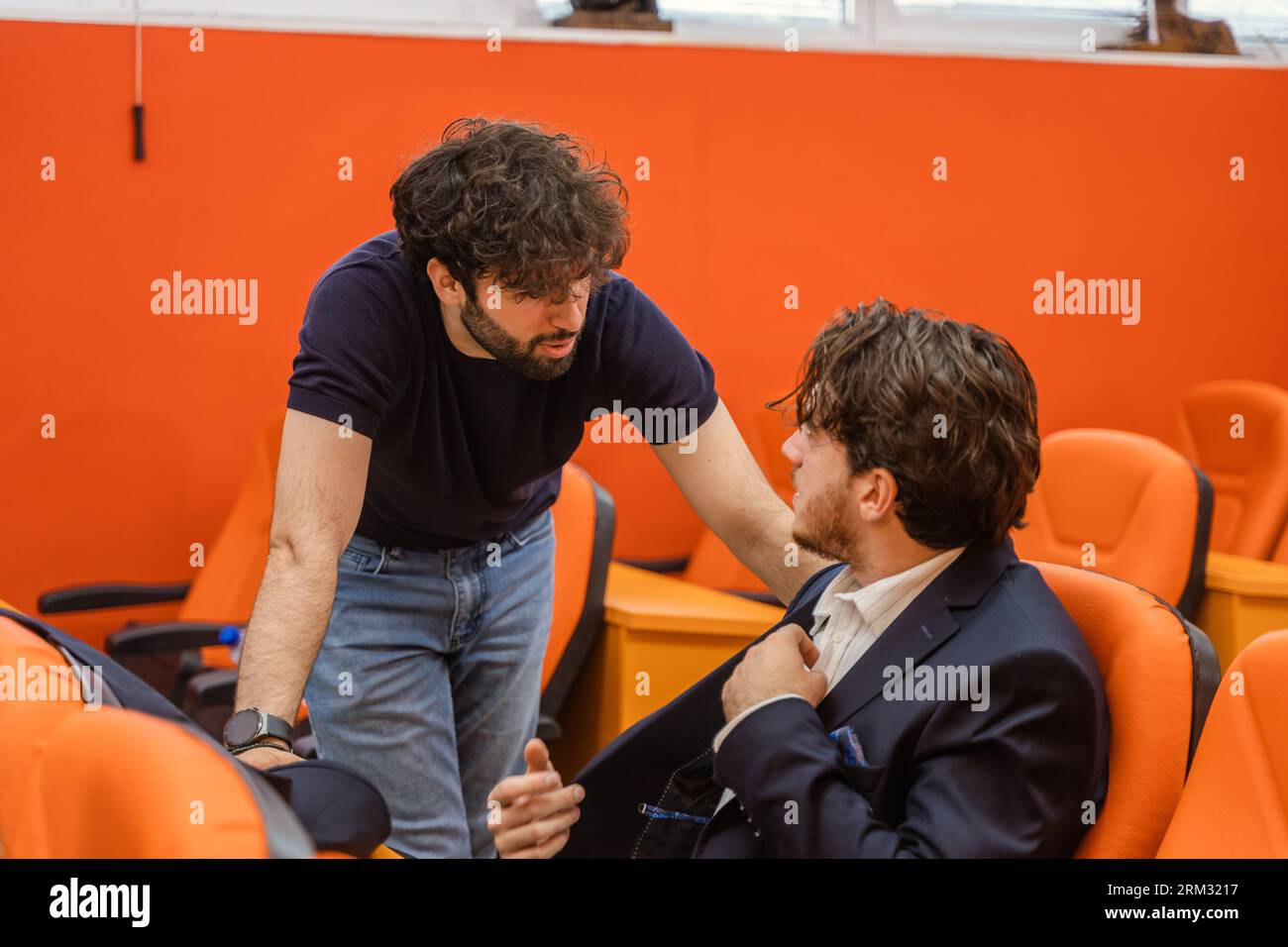 Two classmates talking while on a break after a lecture ended Stock ...