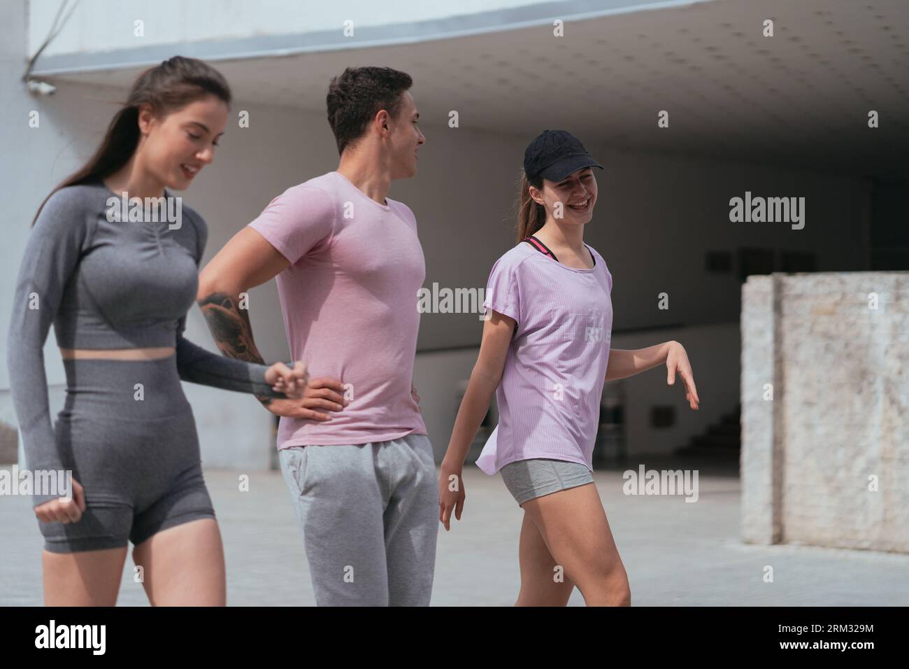 Handsome male sportsman joking with his female friend. Sports friends ...