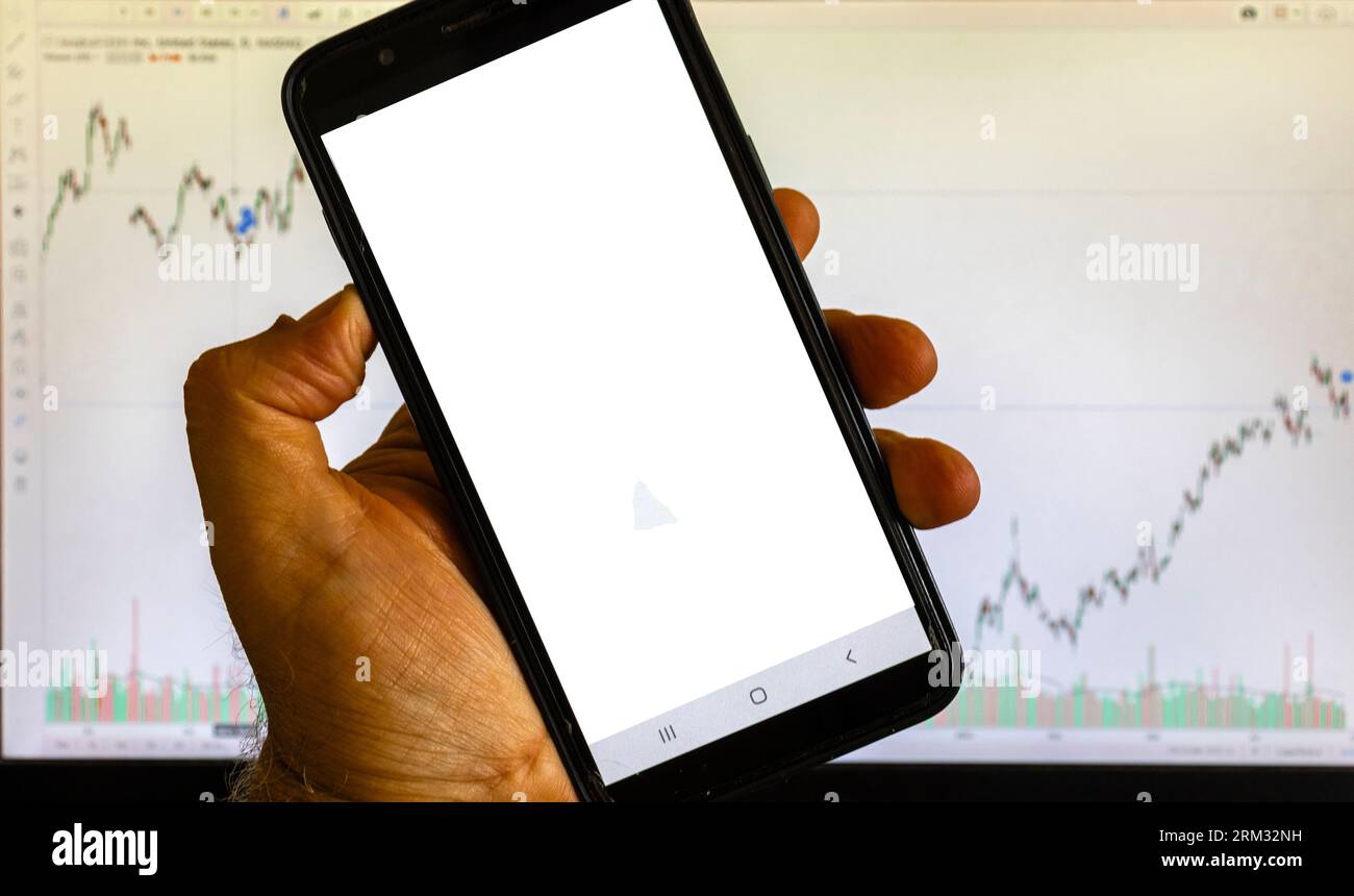 Mock up blank seen on an smartphone over stock chart background in ...