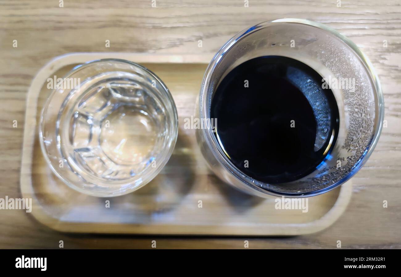 Coffee and water background, black coffee and a glass of water close ...